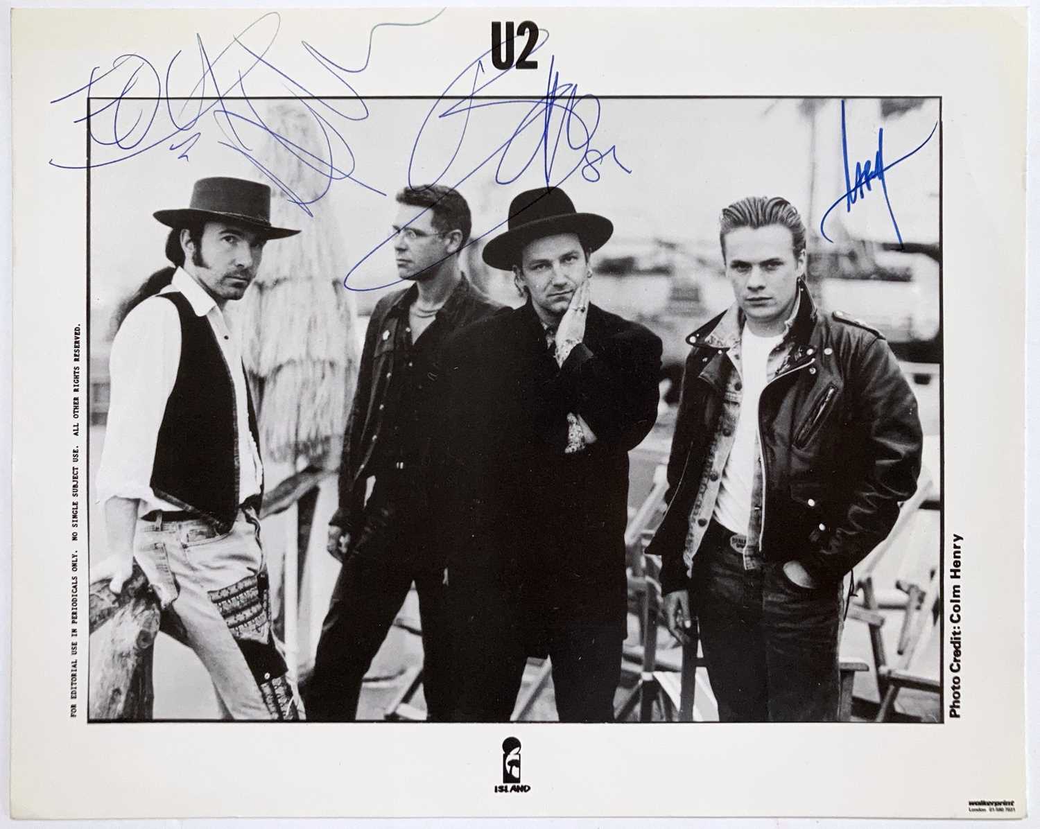 Lot 311 - U2 - A SIGNED PHOTOGRAPH.